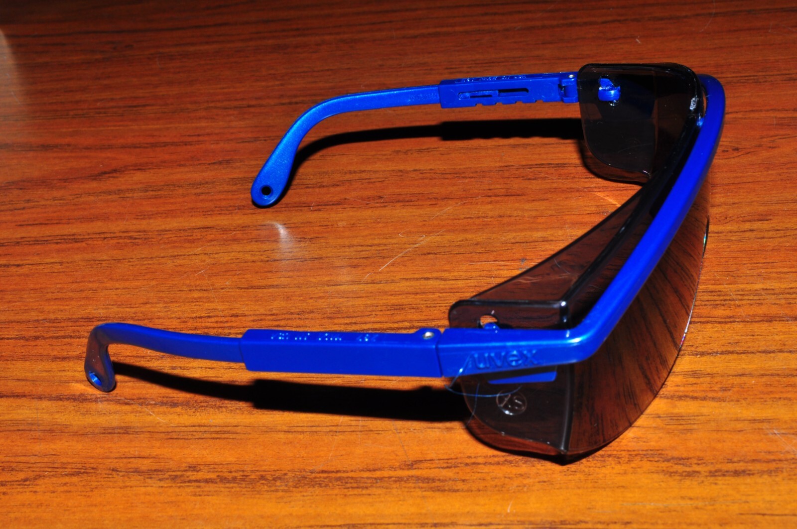 Uvex Astrospec Gray Lens Blue Frame Ultra Hard Coat Sun Safety Glasses uvex-astrospec-gray-lens-blue-frame-ultra-hard-coat-sun-safety-glasses