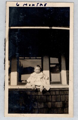 1930s Infant Child sitting dangerously on window sill for photo ...