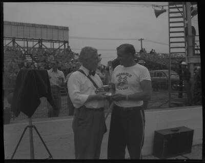 Driver Walt Ader speaks into a microphone as he is interviewed 1950 ...