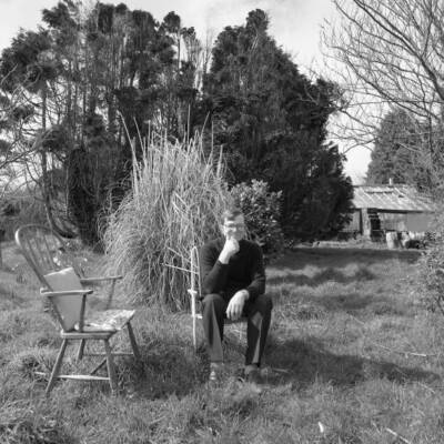 English writer novelist Colin Wilson posed in the garden of his ho ...