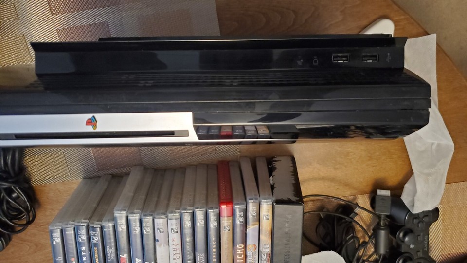 PS3 console 60GB with 2 controllers and 18 games. In very good ...