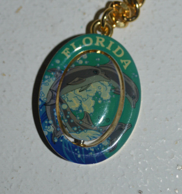 FLORIDA KEY CHAIN DOLPHIN CENTER SPINS GOLD TONE CHAIN VGC | eBay