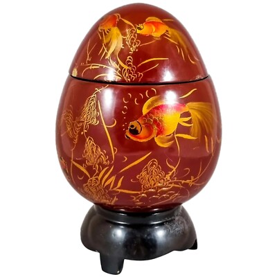 Egg-shaped large red lacquerware box on stand, gilded and painted with ...