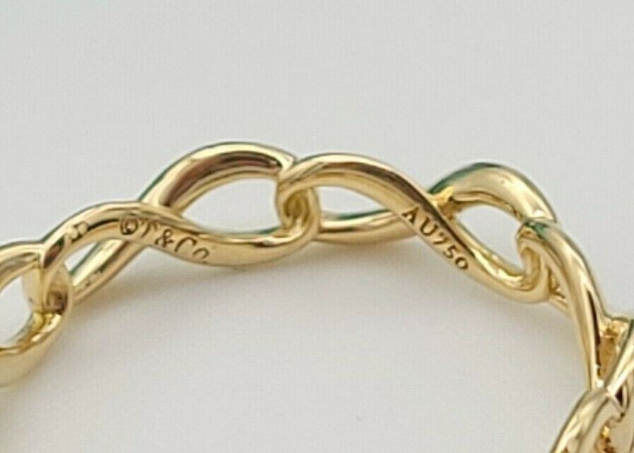 Tiffany & Co. AU750 18 Karat Yellow Gold Infinity Narrow Tiffany & Co. AU750 18 Karat Yellow Gold Infinity Narrow