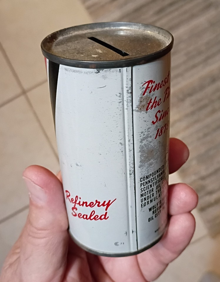 Three Vintage "WOLF'S HEAD OIL" AD ITEMS....CAN BANK + SERVICE STICKERS ...