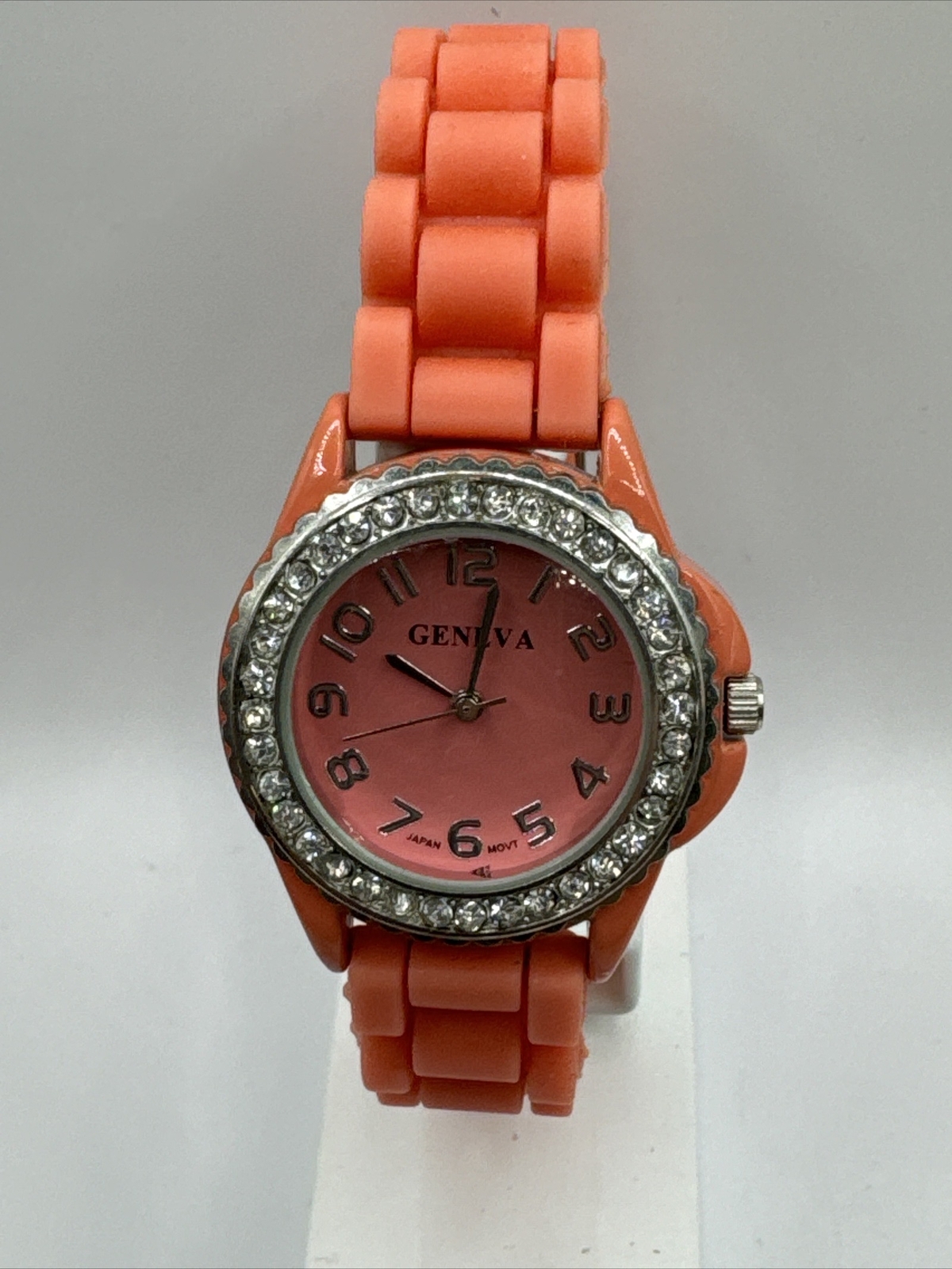 Geneva ladies watch,peach colored band with buckle,rhinestones on bezel ...