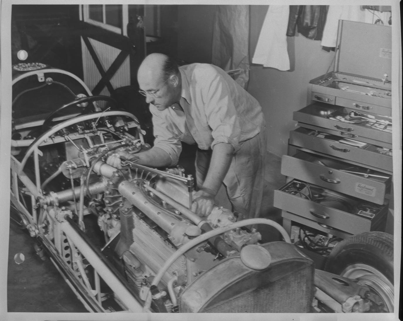 Mechanic Harry Stevens works on the engine to Johnnie Parsons' 1950 ...