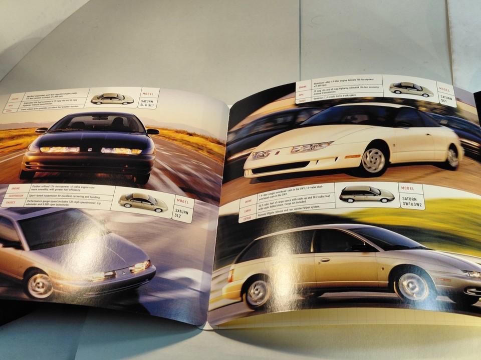 1998 Saturn brochure. New. 14 pages w foldout. A Different Kind of ...