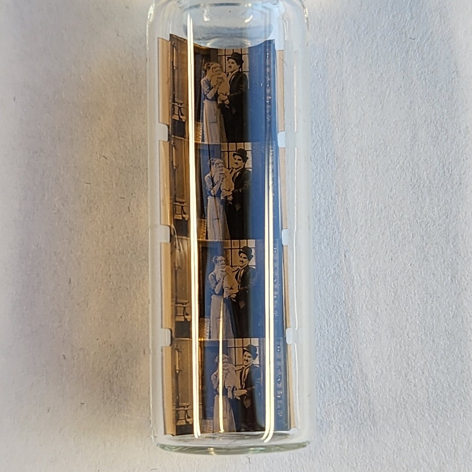 charlie chaplin vintage film cells . strip inside a vial, pouch and ...