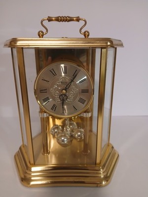 Vintage Bulova Brass quartz clock featuring a rotating pendulum Roman ...