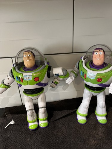 Two talking Buzz lightyear figures . ***One has the front of his helmet ...