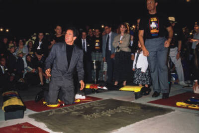 Warren Beatty wearing a grey suit over a black crew neck sweat- 1990 ...