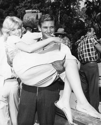 Actor Rod Taylor carrying actress Yvette Mimieux arms circa 1960 Old ...