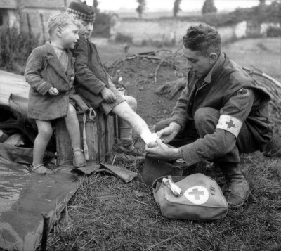WWII B&W Photo Canadian Medic Treats Injured French Child WW2 France ...