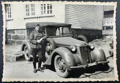 A German soldier during World War II poses in front of a Wanderer W24 ...