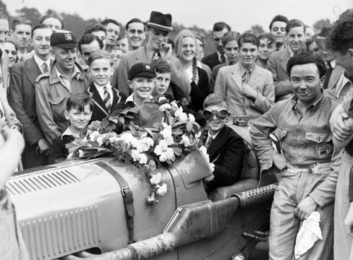 John Wakefield sits on the rear wheel of his ERA B 1938 Motor Racing ...