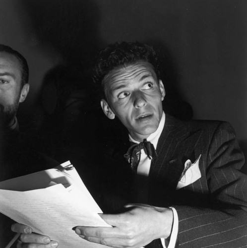 Frank Sinatra holds a script while performing on the radio show 'S- Old ...