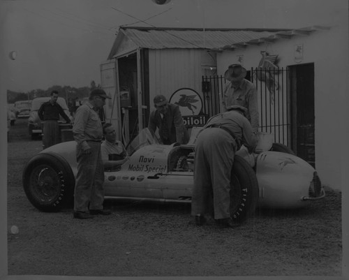 Duke Nalon sits in the #54 Novi Mobil Special as men examine hi 1949 ...